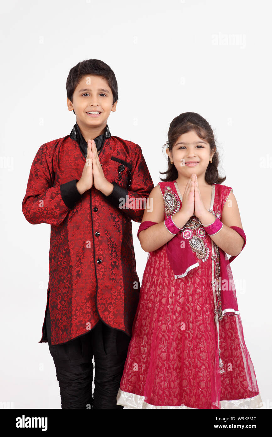 Two children greeting with hands joined Stock Photo - Alamy
