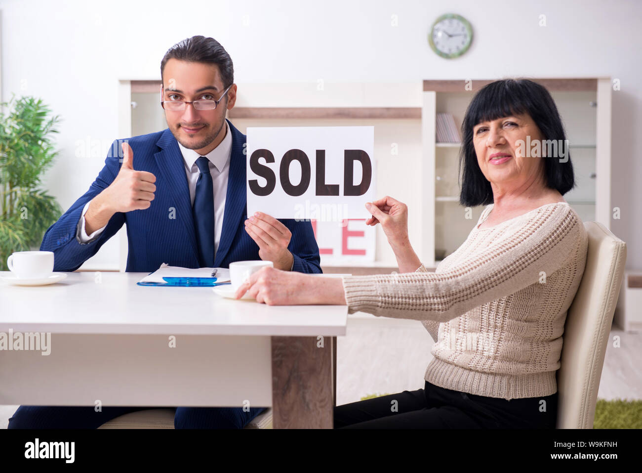 The male real estate agent and female client in the apartment Stock ...
