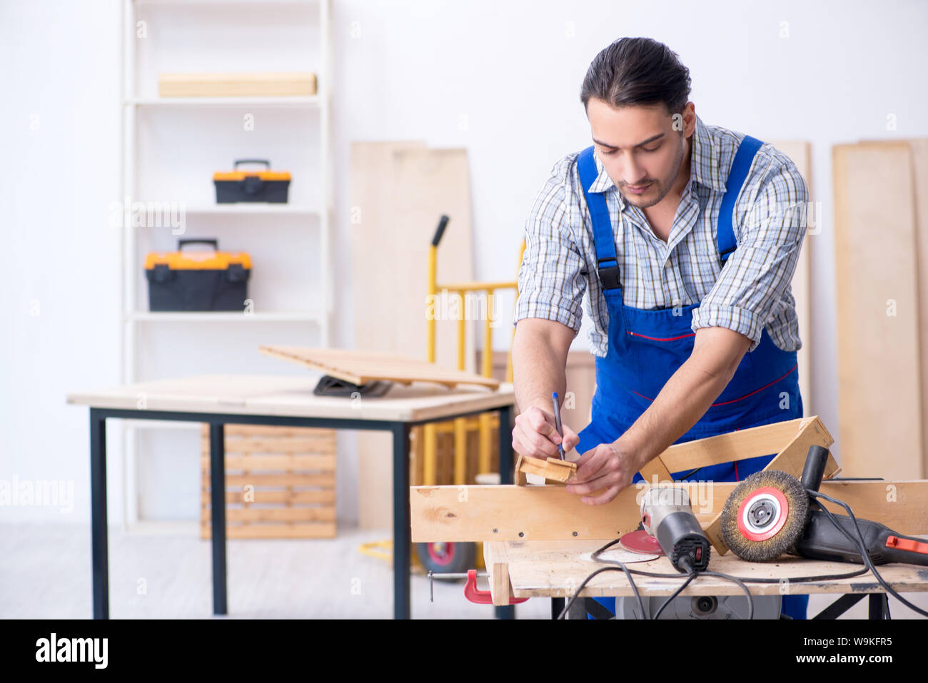 Young carpenter marking plywood hi-res stock photography and images - Alamy