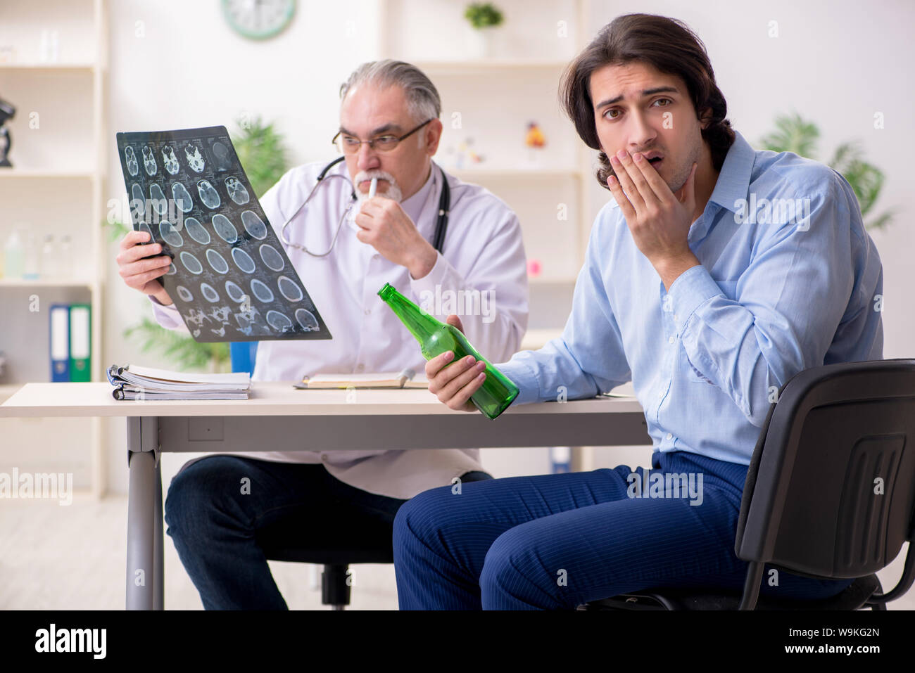 The young male alcoholic visiting old doctor Stock Photo - Alamy