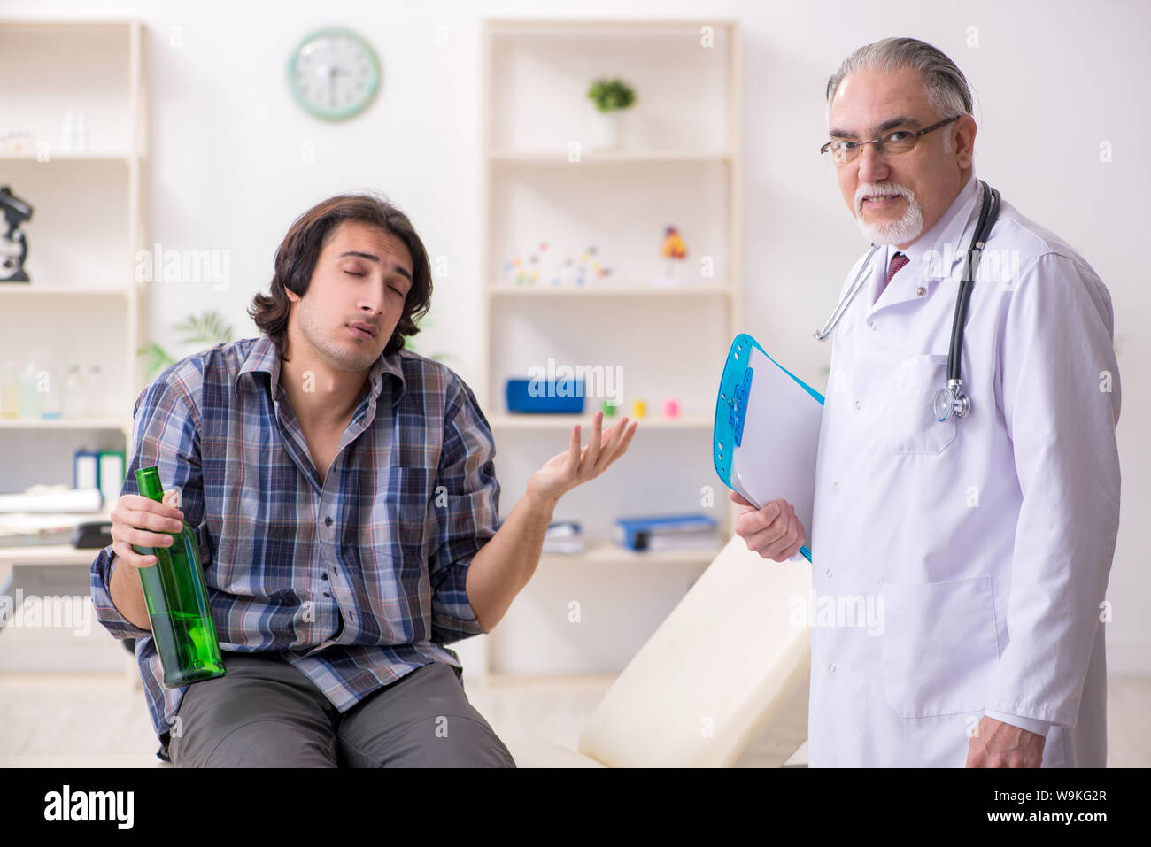 The young male alcoholic visiting old doctor Stock Photo - Alamy