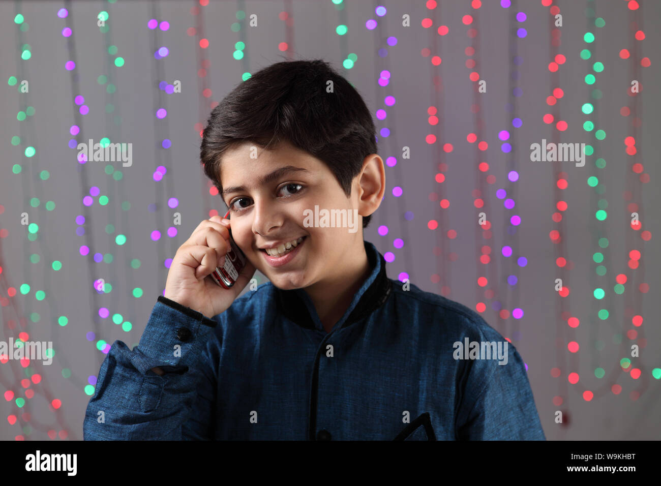 Boy talking on a mobile phone and smiling Stock Photo - Alamy