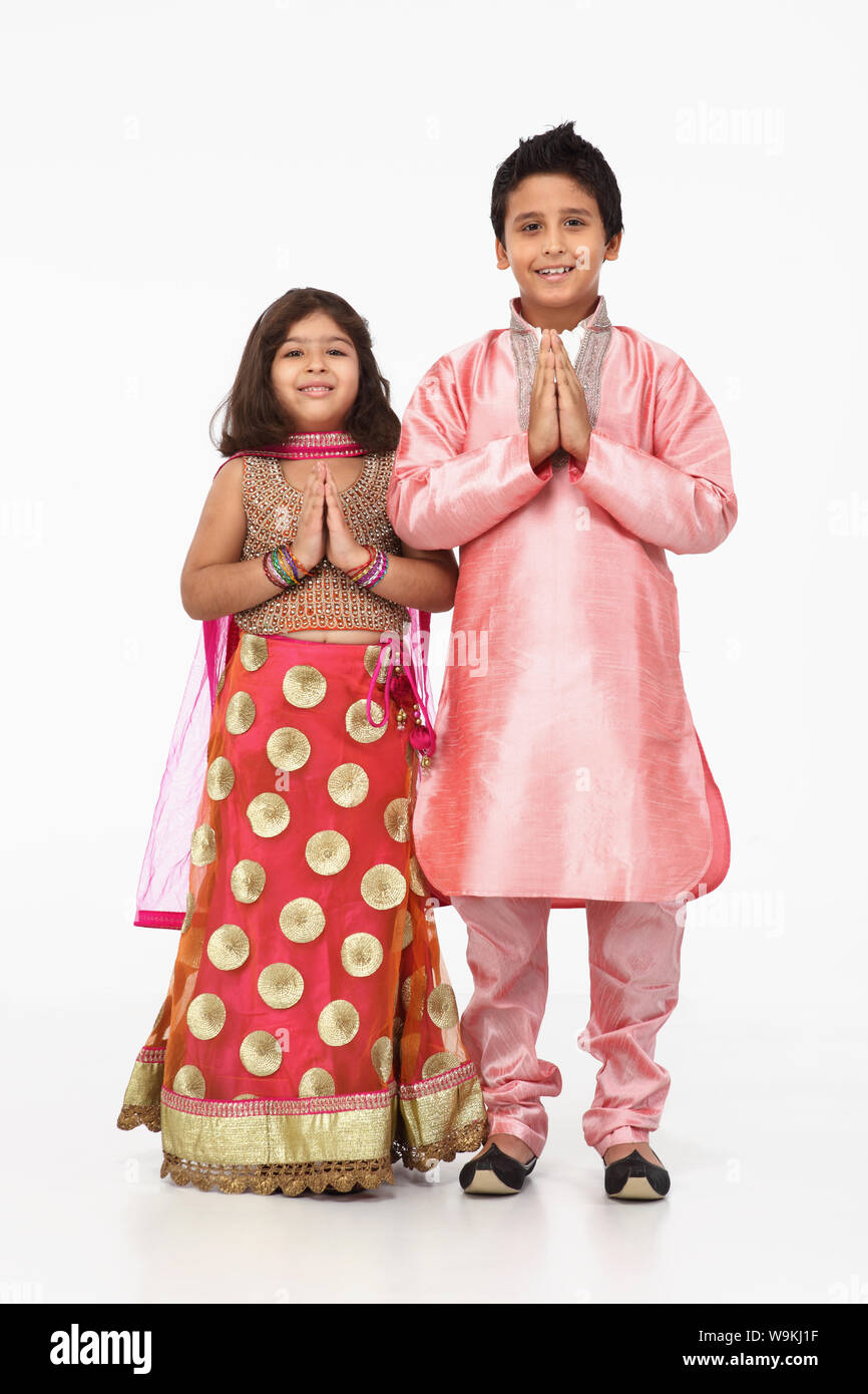 Two children greeting with hands joined Stock Photo - Alamy