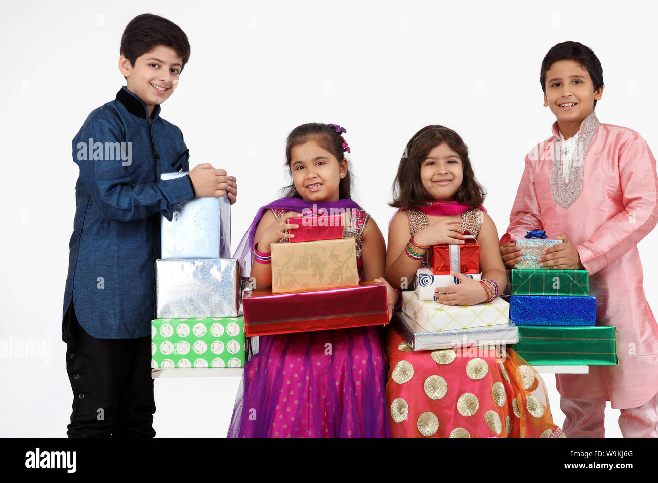 Group of children holding gift boxes and smiling Stock Photo - Alamy