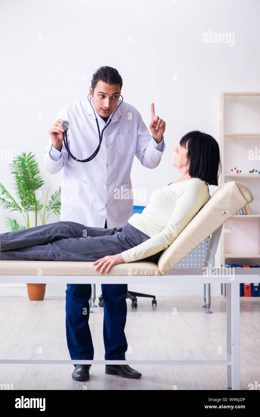 Doctor checking senior man lungs hi-res stock photography and images ...