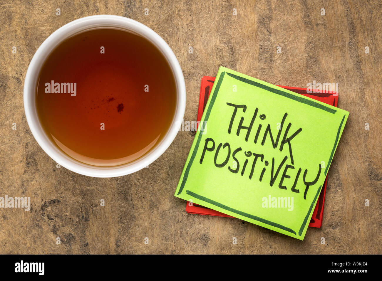 think positively motivational reminder - handwriting on a sticky note ...