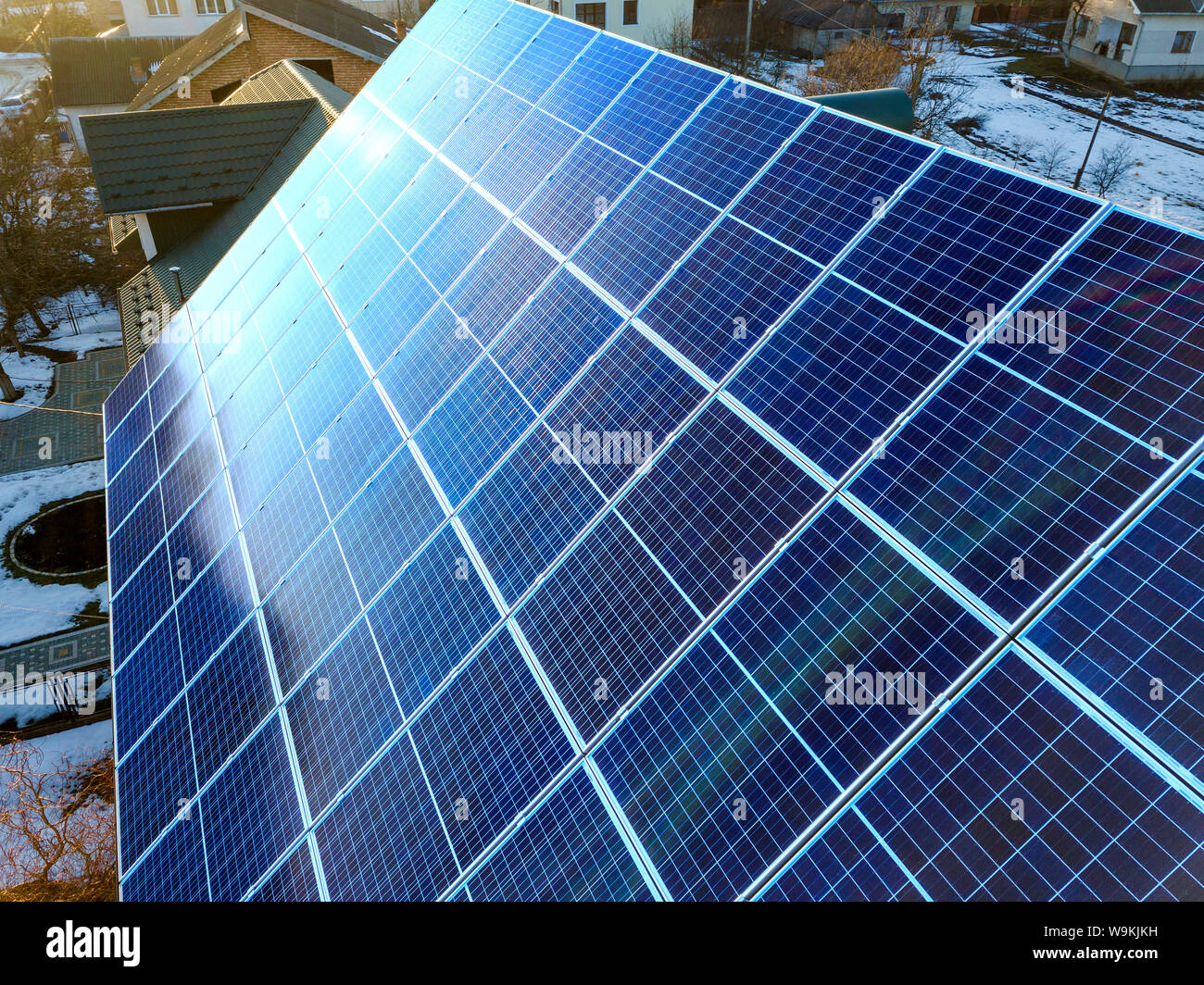 Close-up surface of lit by sun blue shiny solar photo voltaic panels ...