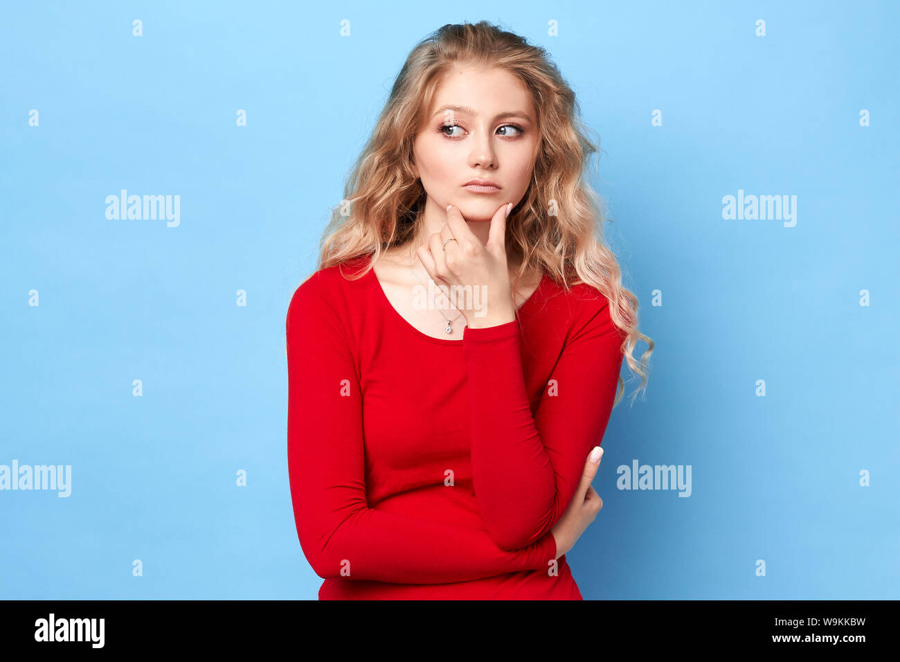 Close up portrait of curious cheerful charming girl having doubtful ...