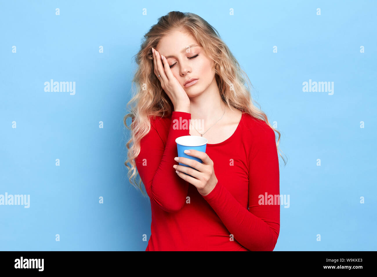 Tired exhausted sleepy woman with closed eyes covers half of face with ...