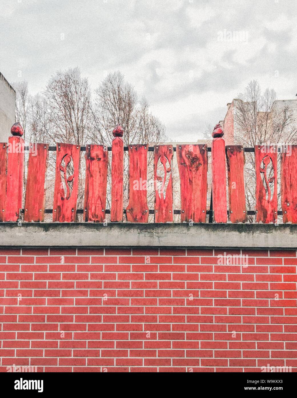 Red brick wall with wooden fence or railing Stock Photo - Alamy