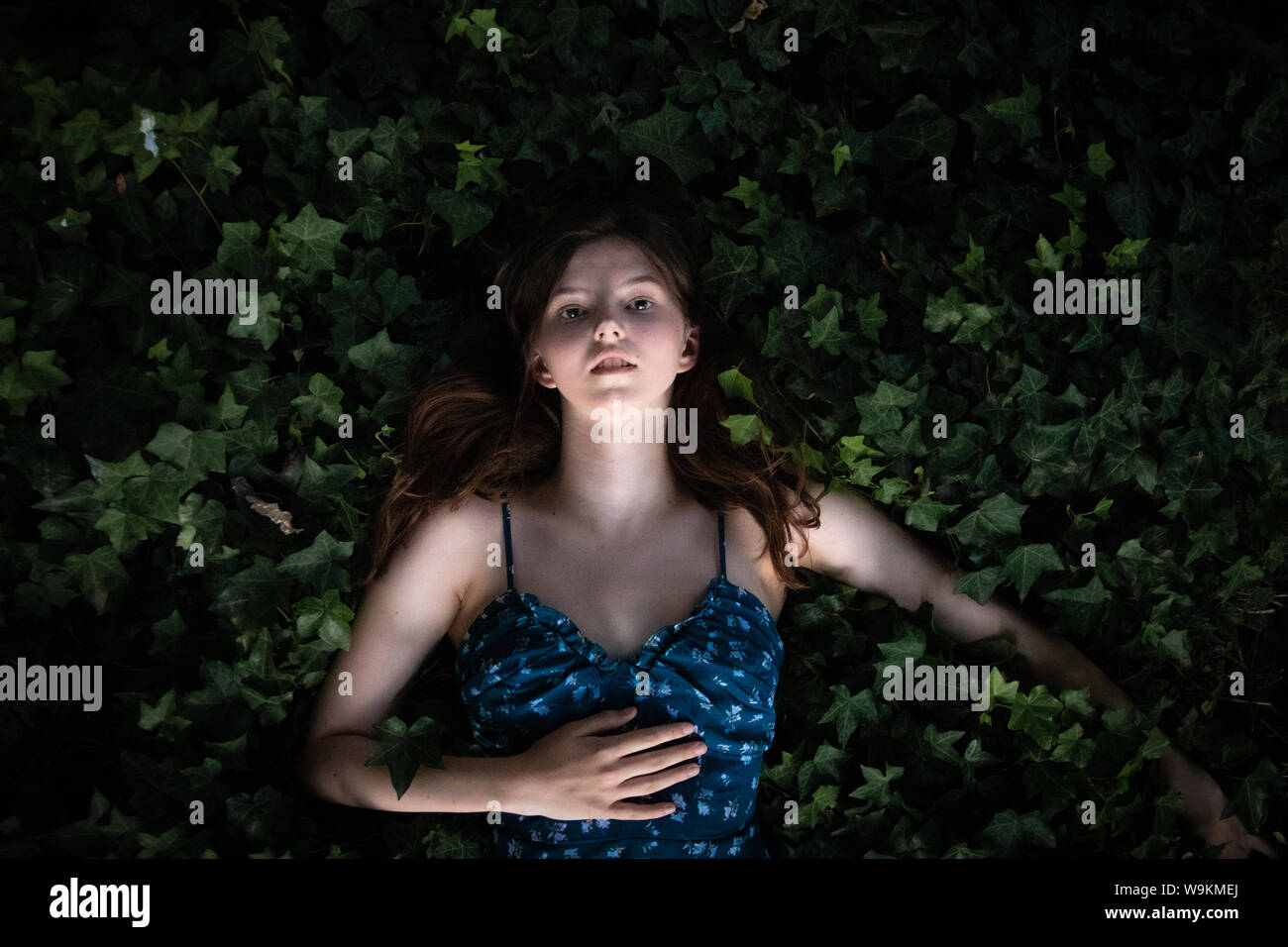 Model facing backwards against a tree Stock Photo - Alamy
