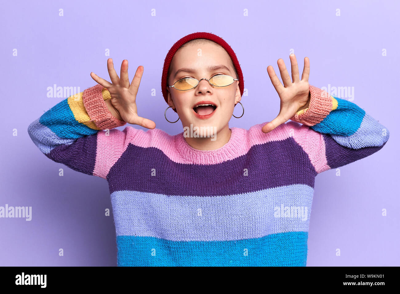 talented cool singer in stylish sweater and hat performing on the stage ...