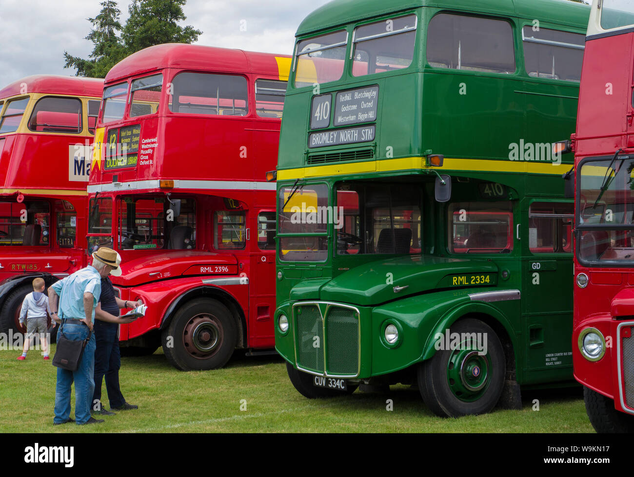 Visitors consult their catalogue to view a pair of RM Routemaster Buses ...
