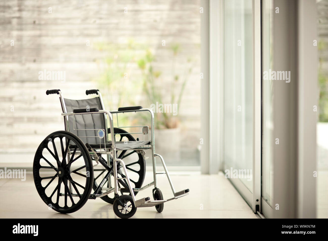 Empty wheelchair in a home interior Stock Photo - Alamy