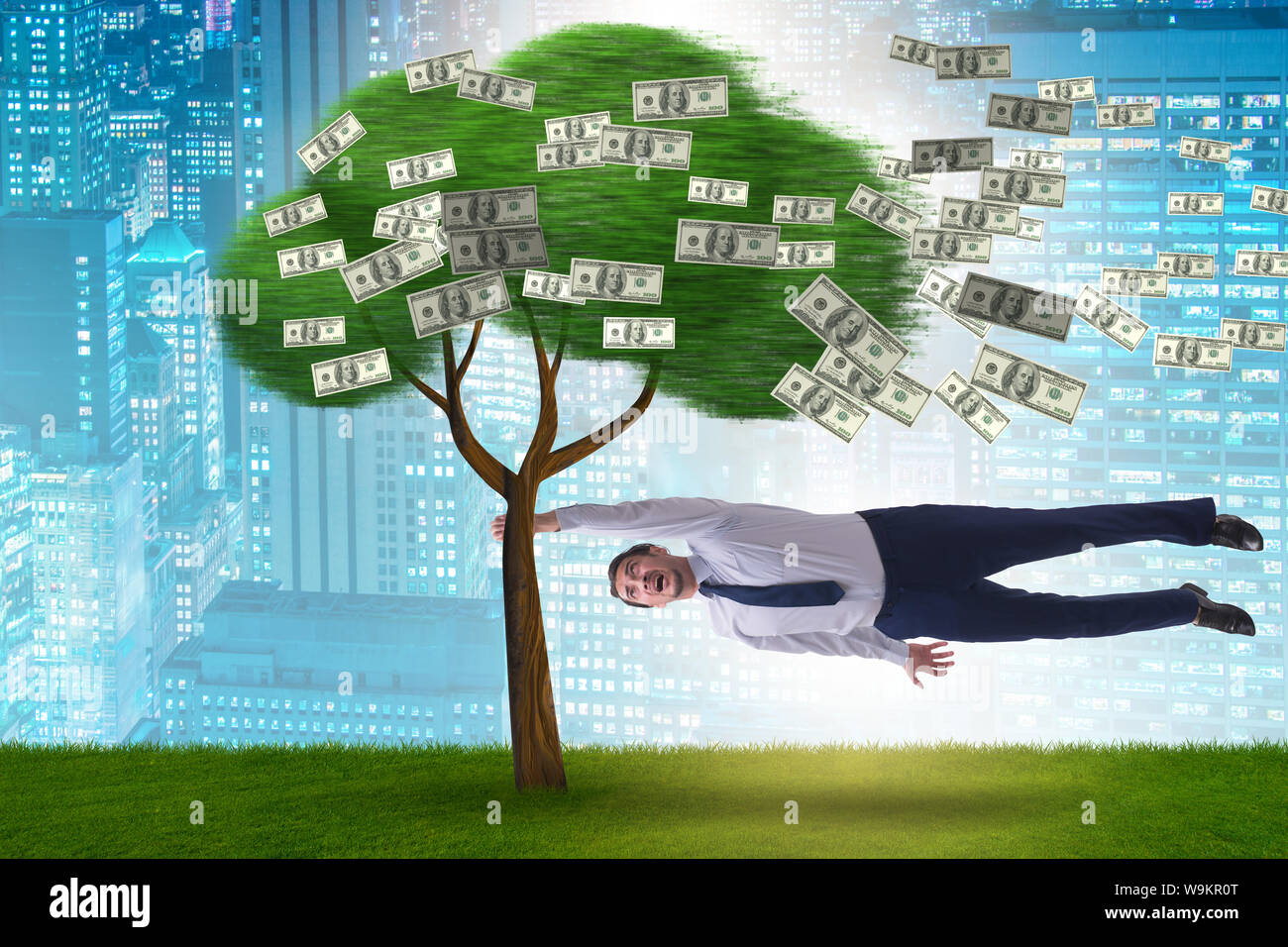 The businessman blown away from the money tree Stock Photo - Alamy