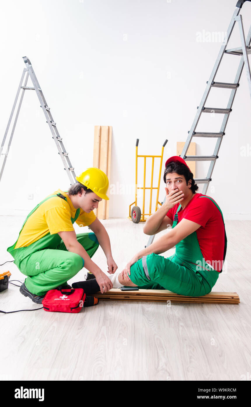 The injured worker and his workmate Stock Photo - Alamy