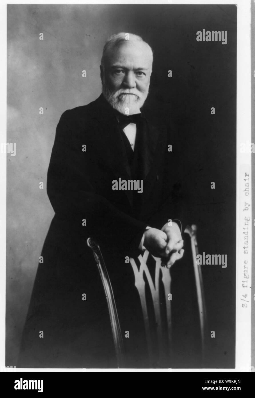 Andrew Carnegie, three-quarter length portrait, standing behind chair ...