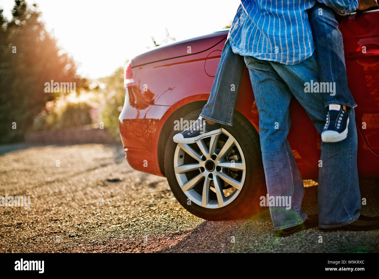 Low section view of couple being affectionate by their car Stock Photo ...