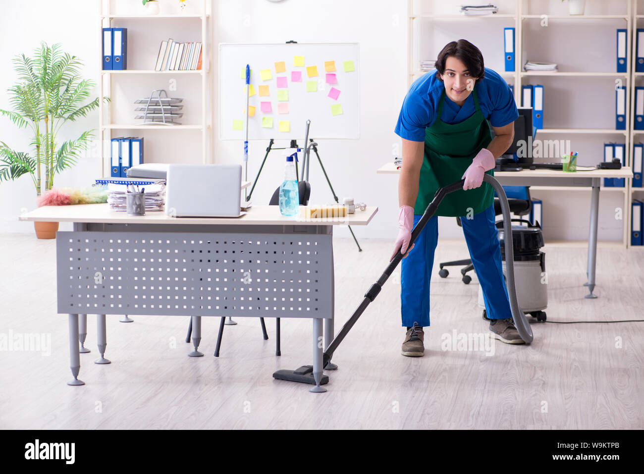 The male handsome professional cleaner working in the office Stock ...