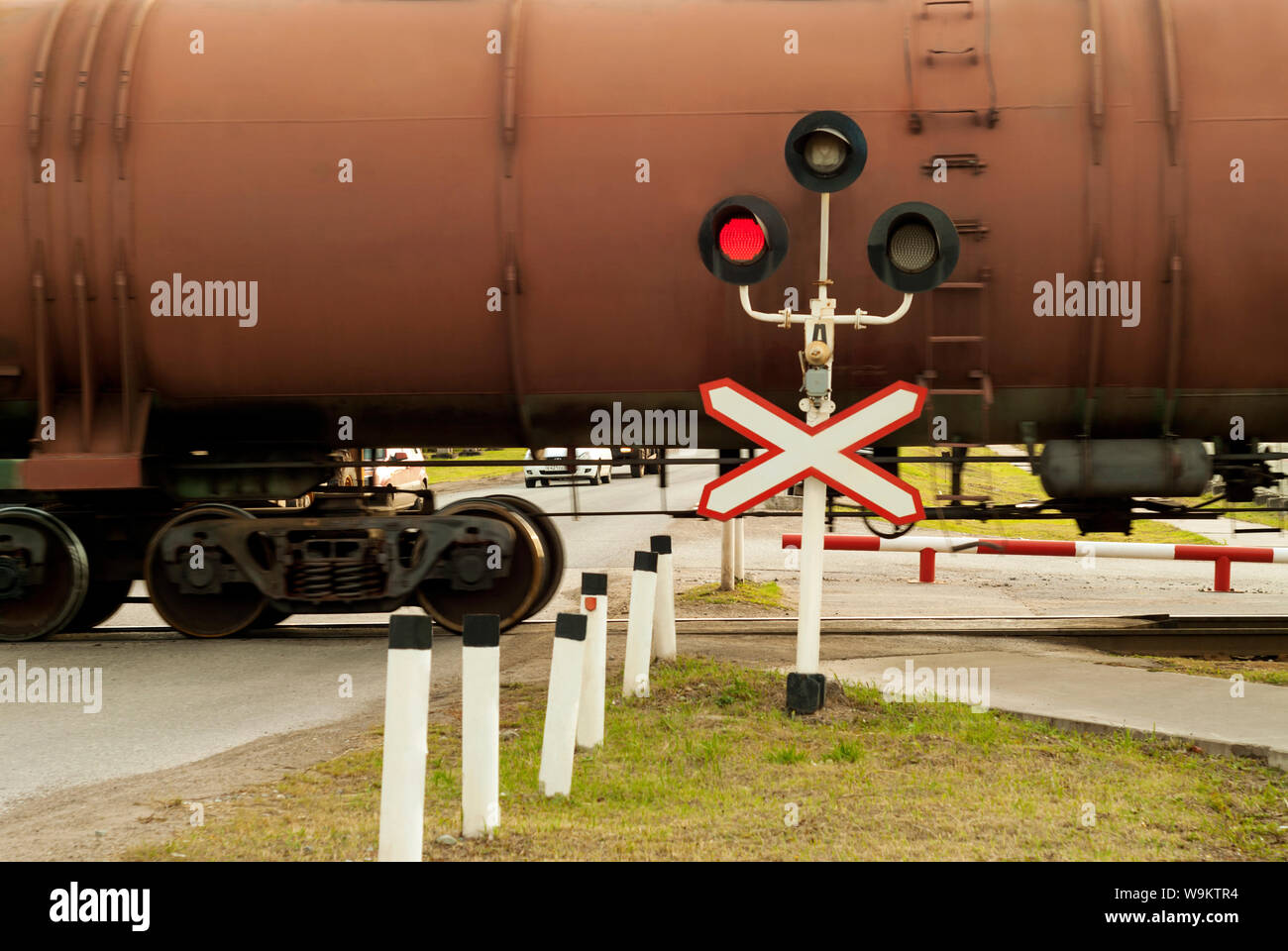traffic light and sign on the railway crossing during the passage of a ...