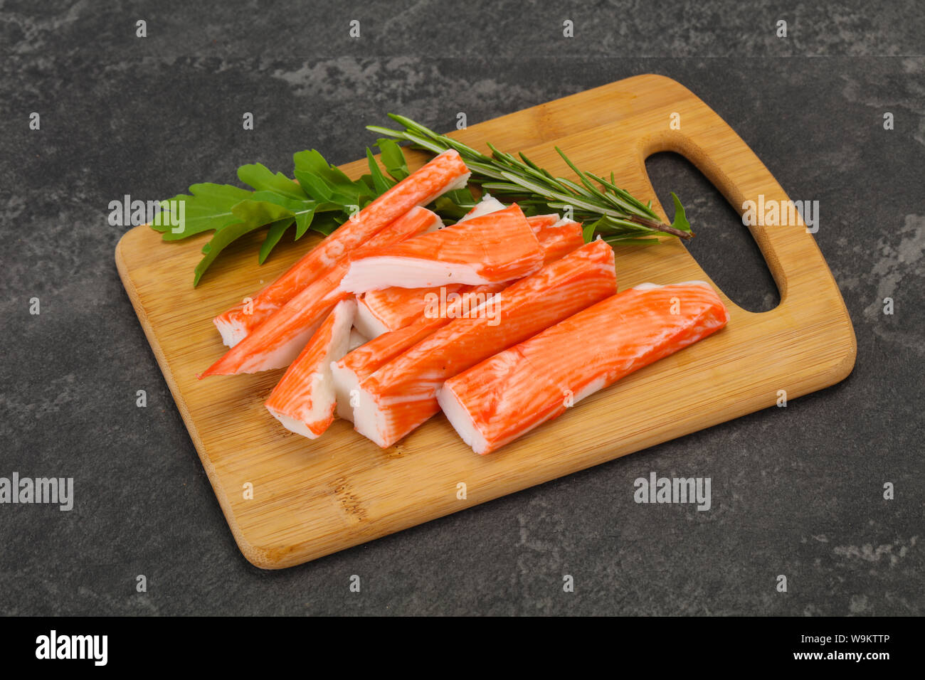Crab stick surimi over wooden board Stock Photo - Alamy