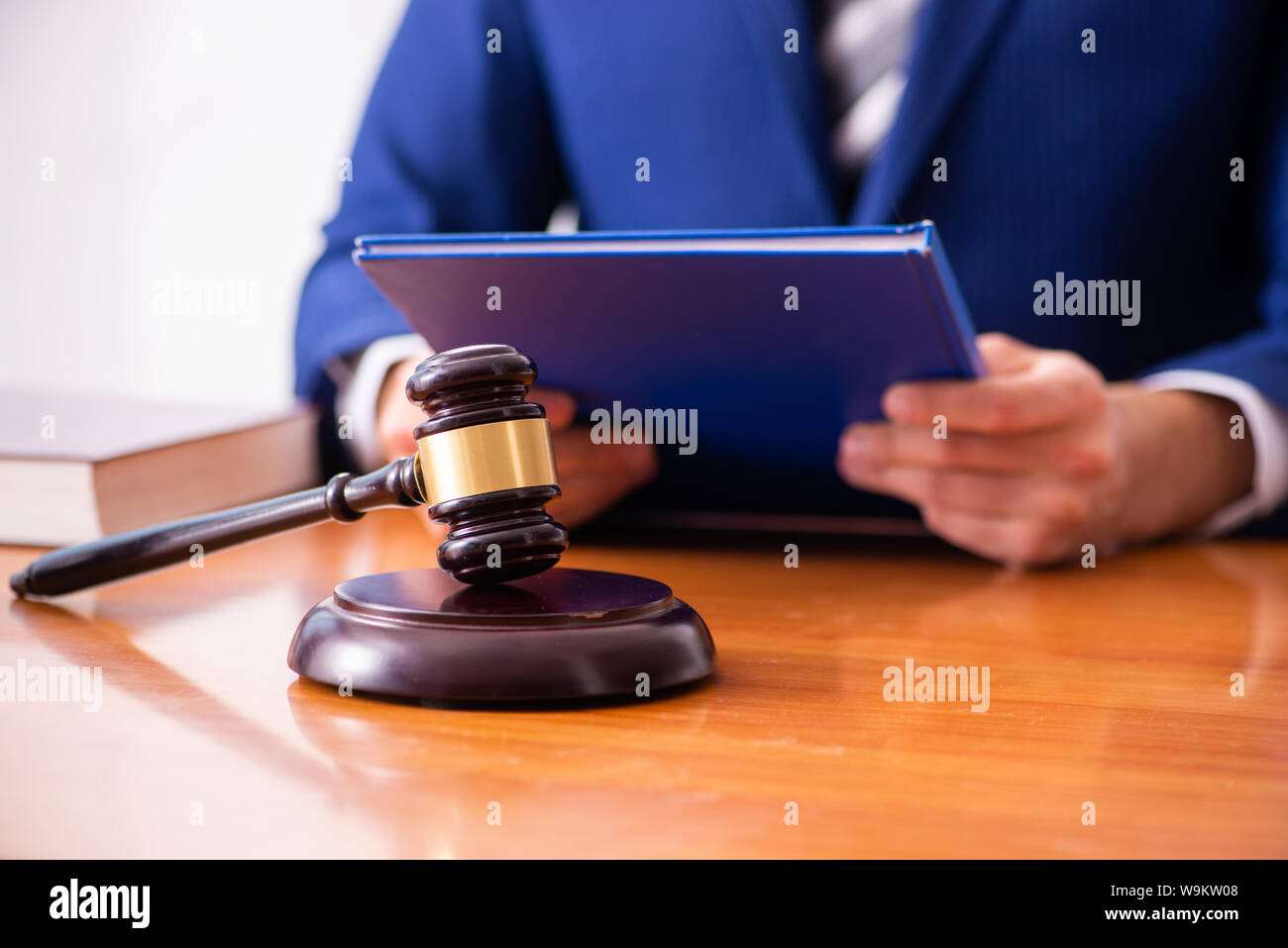 The young male judge sitting in courtroom Stock Photo - Alamy
