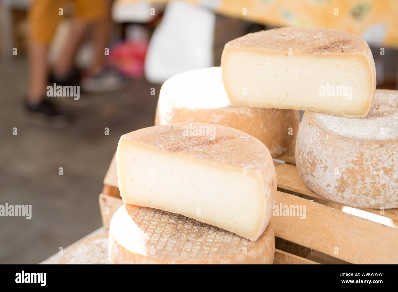 Round and half rounds of sheeps milk cheese on display at artisan ...