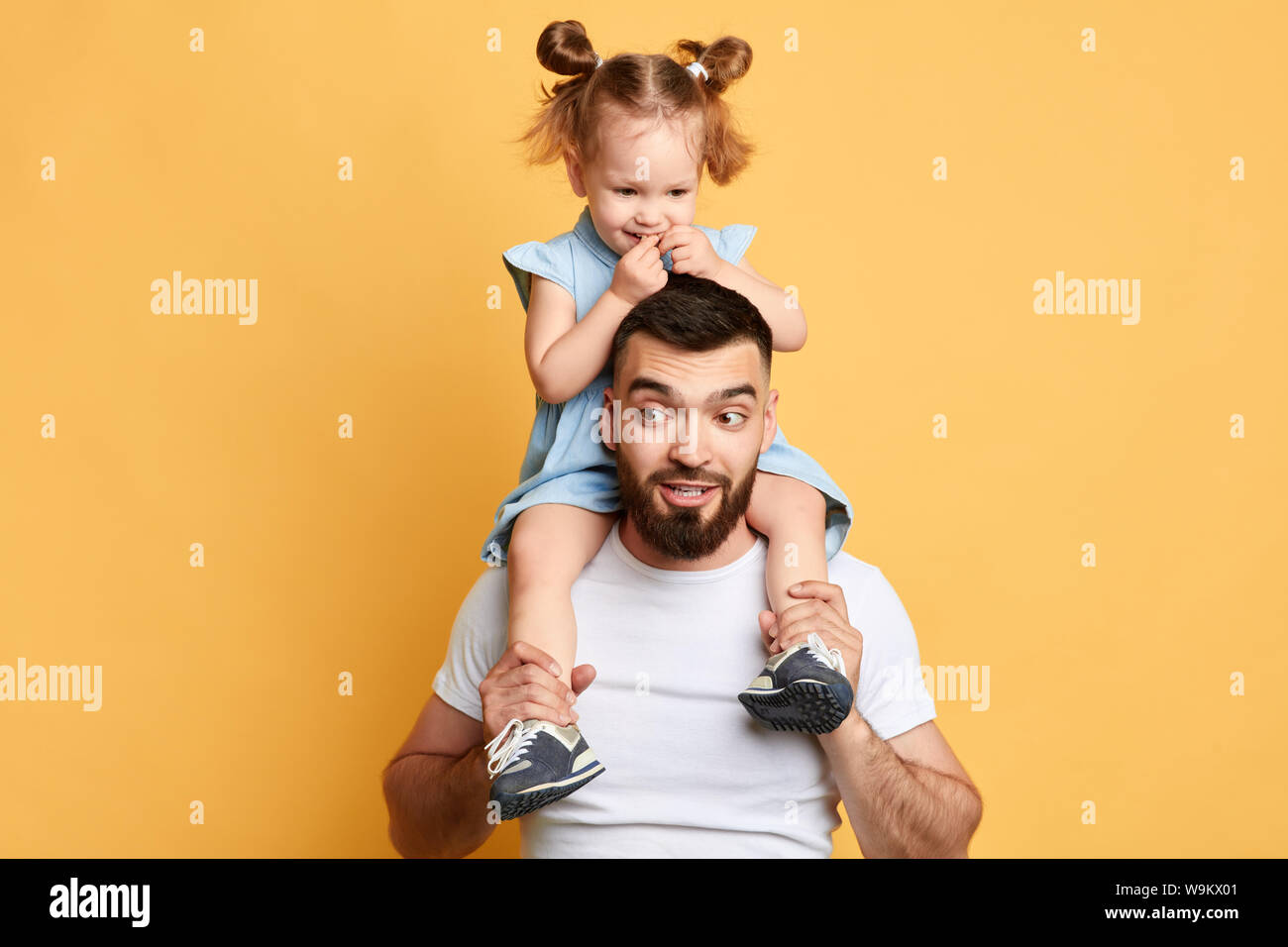 unforgettable time with adorable daddy. close up photo. isolated yellow ...