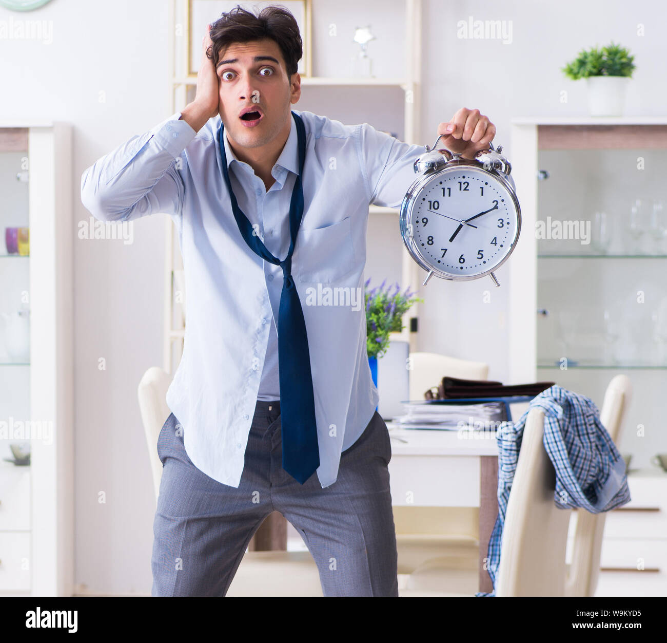 Businessman late for office due to oversleeping after overnight working ...