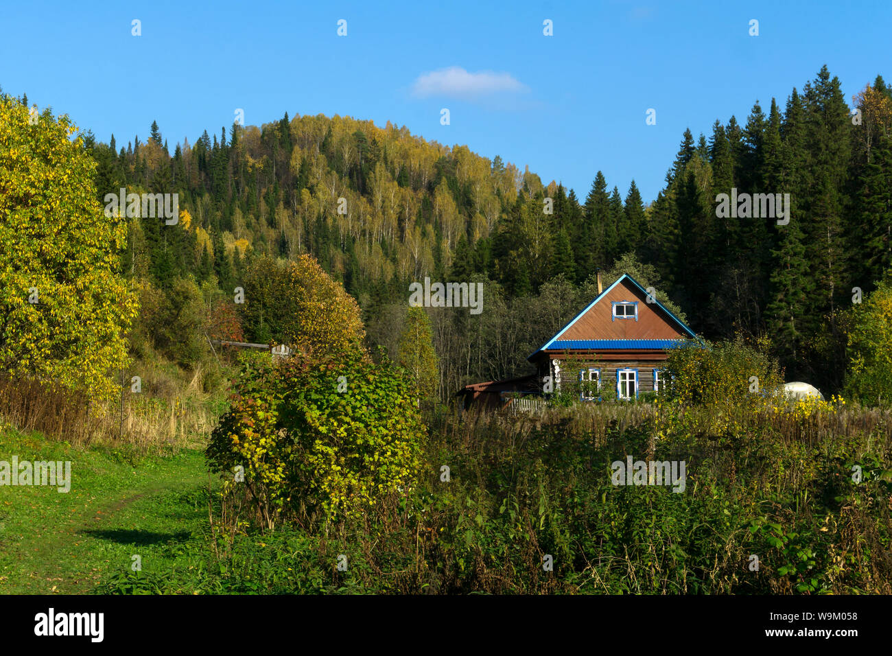small farm in a beautiful autumn valley among wooded hills Stock Photo ...