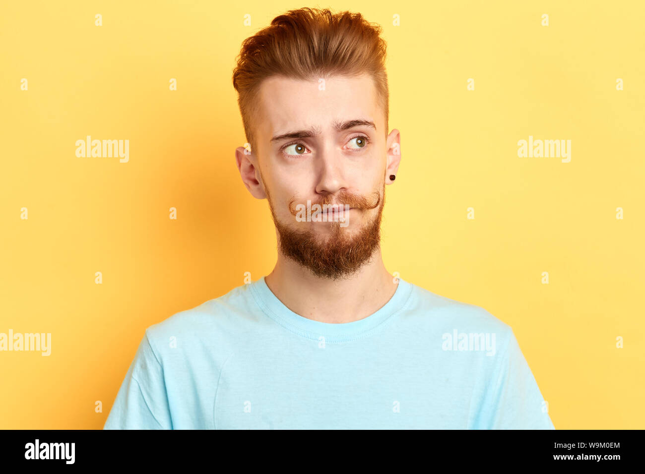 close up portrait. thoughtful young handsome man looking away, trying ...