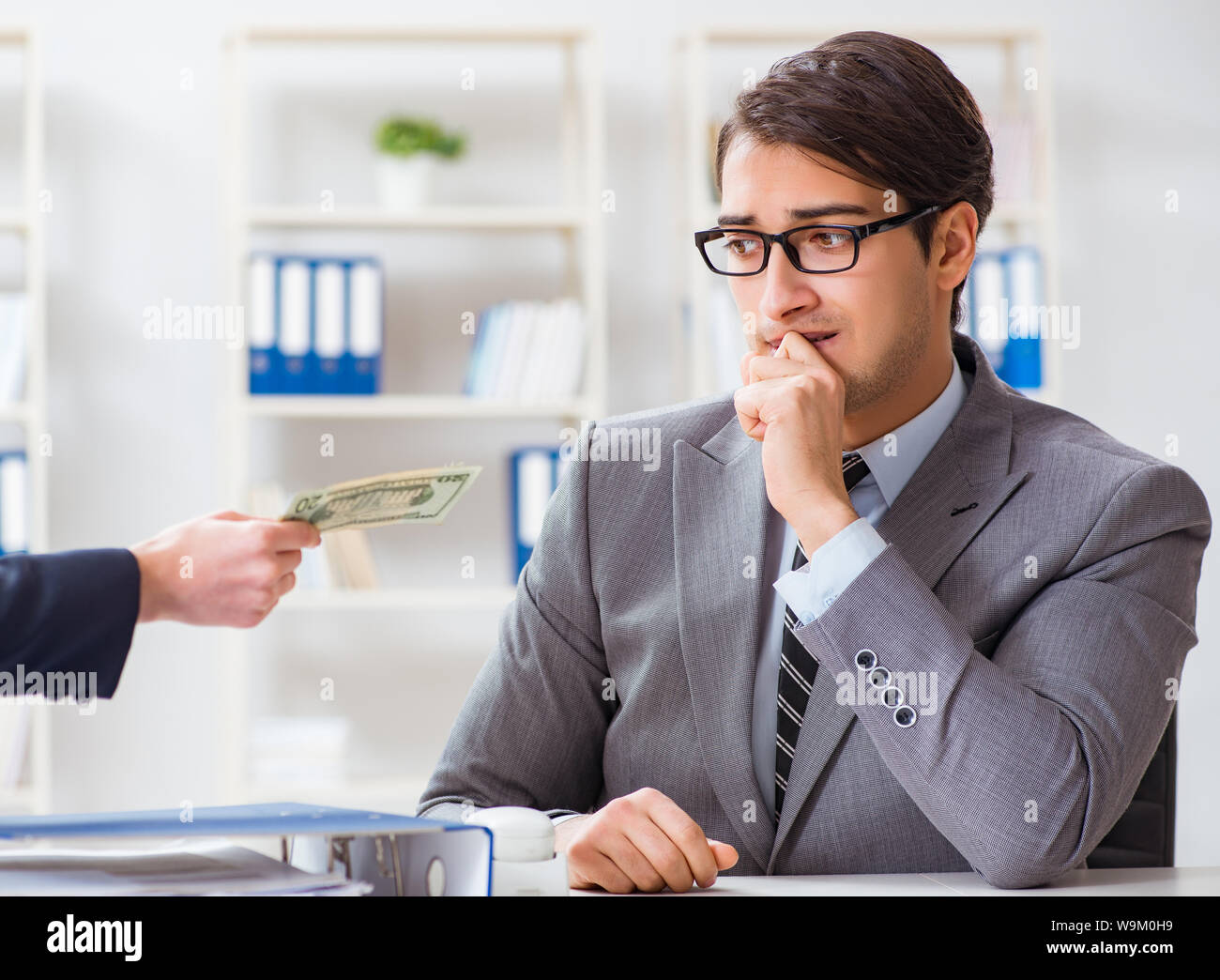 Businessman being offered bribe for breaking law Stock Photo - Alamy