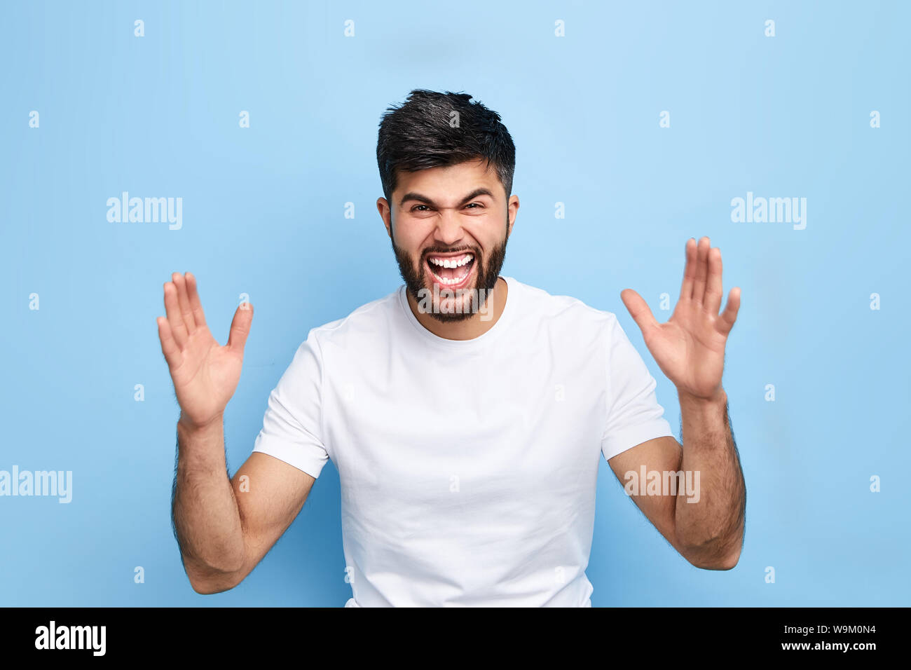 crazy hockey, footbal fan watching TV emotionally. close up portrait ...