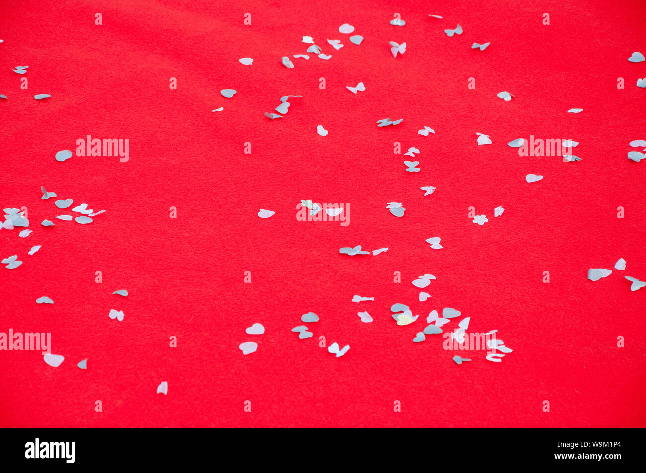 Wedding confetti scattered on a red carpet after being thrown over the ...