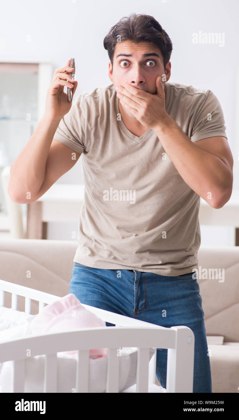 The young father dad frustrated at crying baby Stock Photo - Alamy