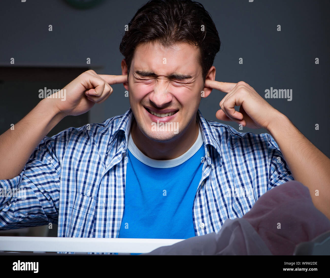The young father under stress due to baby crying at night Stock Photo ...