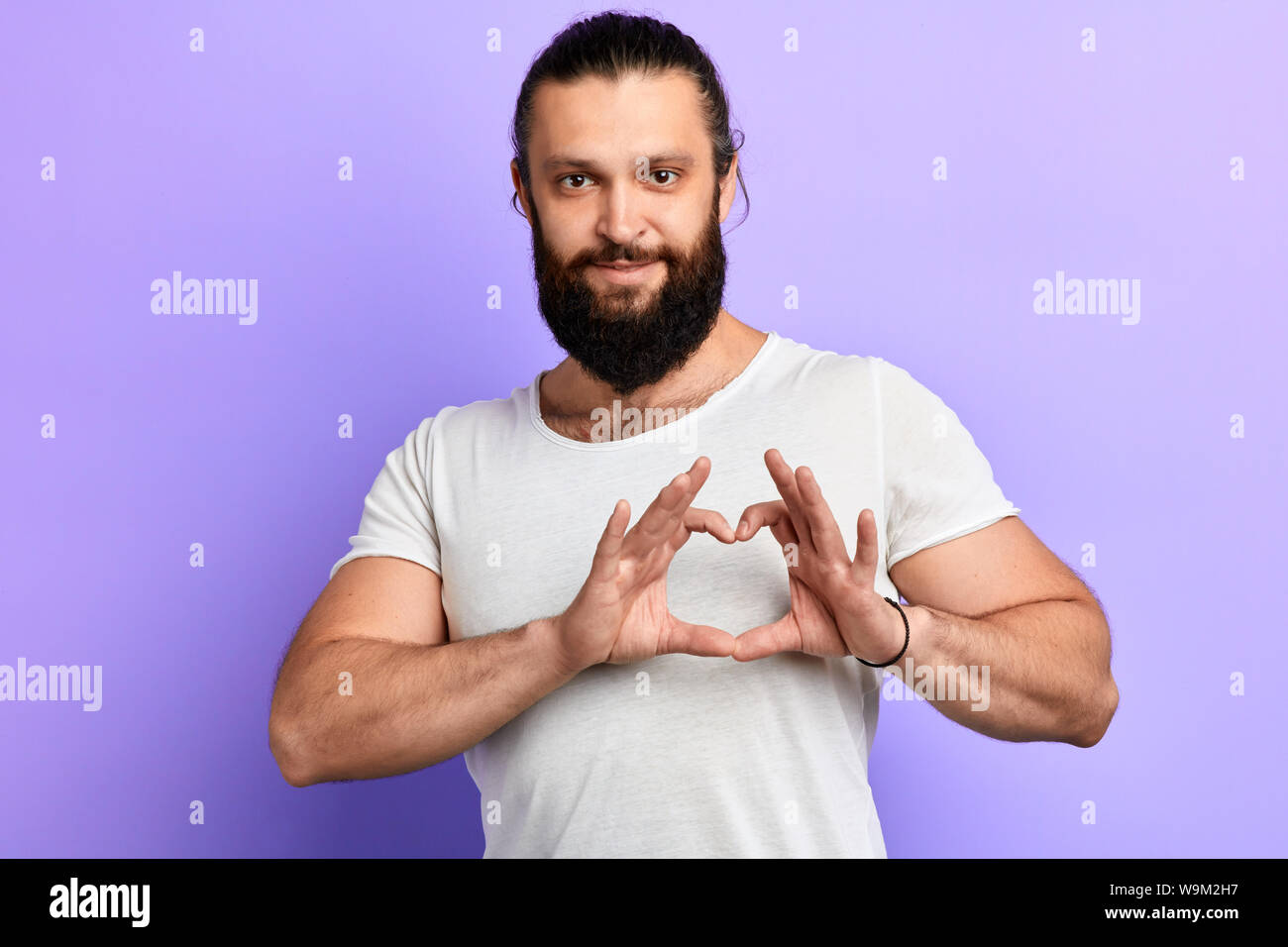 happy handsome cheerful man making heart with fingers.close up portrait ...