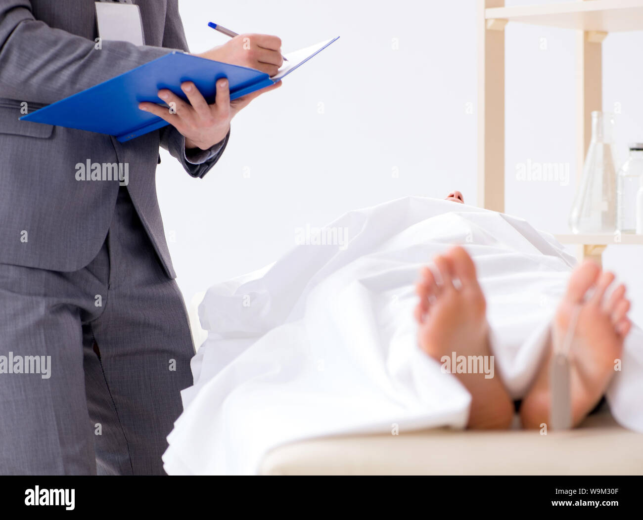 The police coroner examining dead body corpse in morgue Stock Photo - Alamy