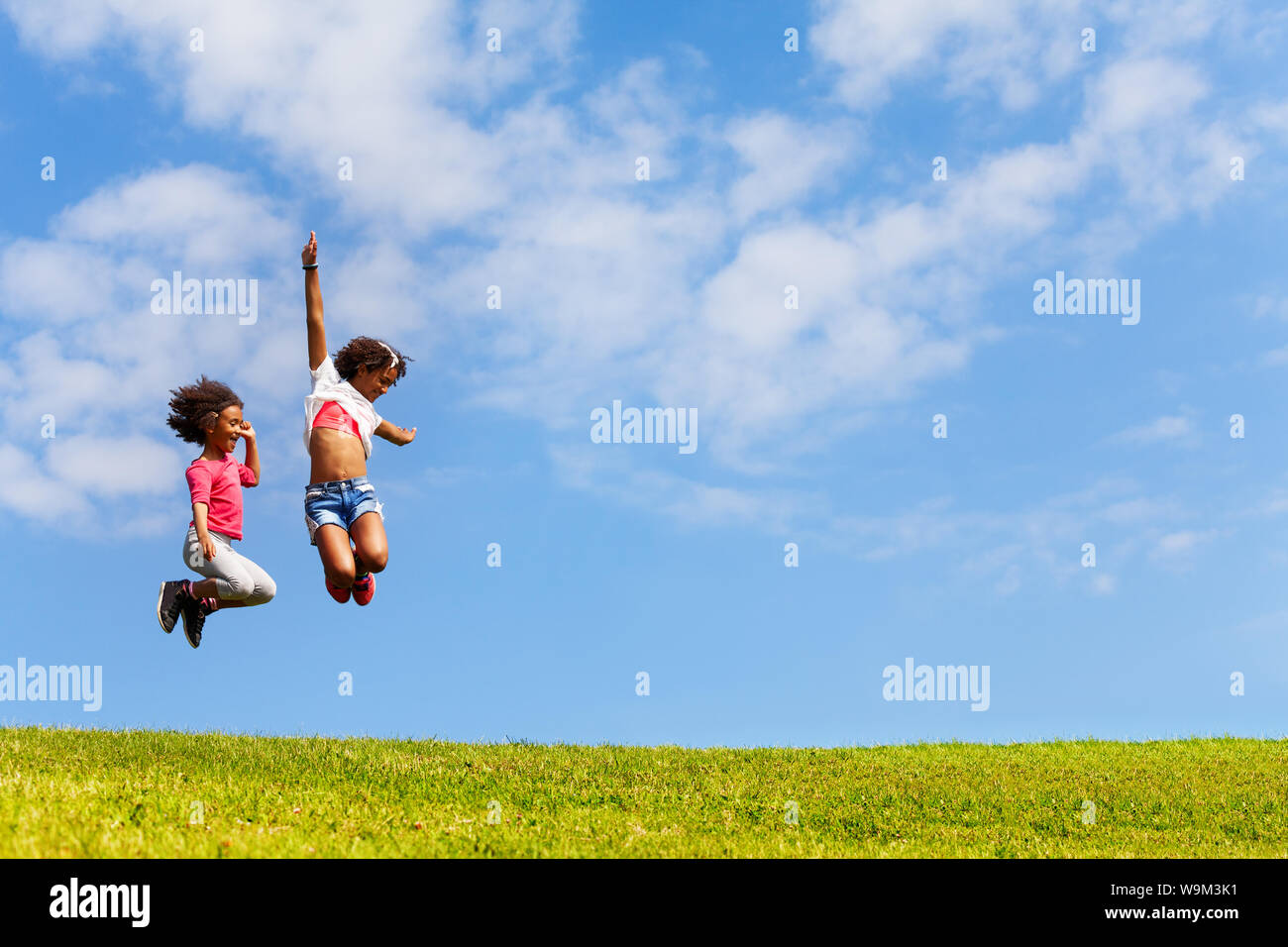 Cute cool looking beautiful girls jump high Stock Photo - Alamy