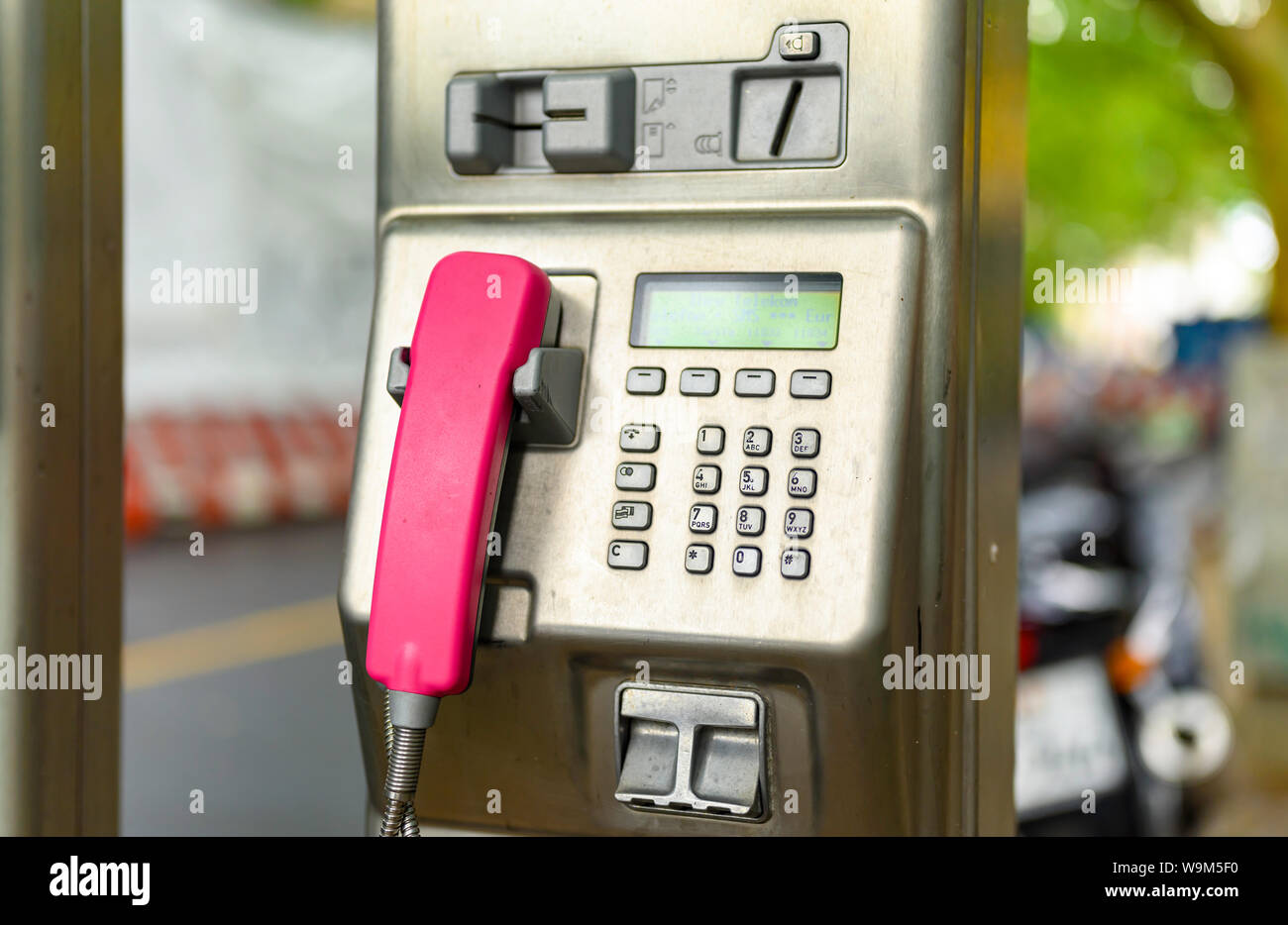 Berlin, Germany - July 13, 2019: View to a public phone with telephone ...