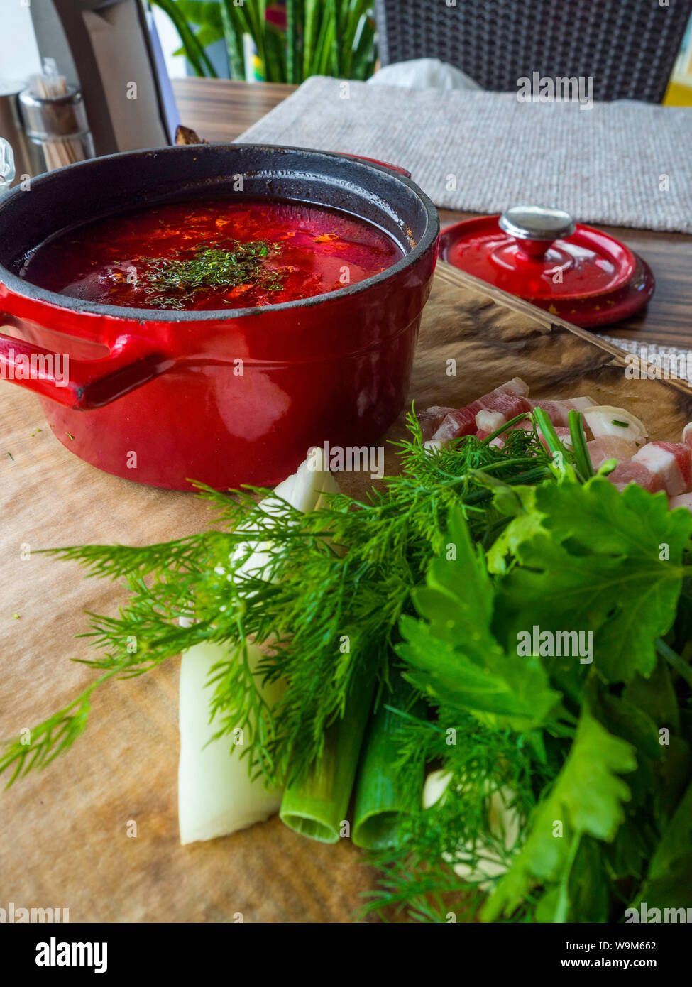 Russian borscht in red pot with garlic, parsley, dill, lard Ukrainian ...
