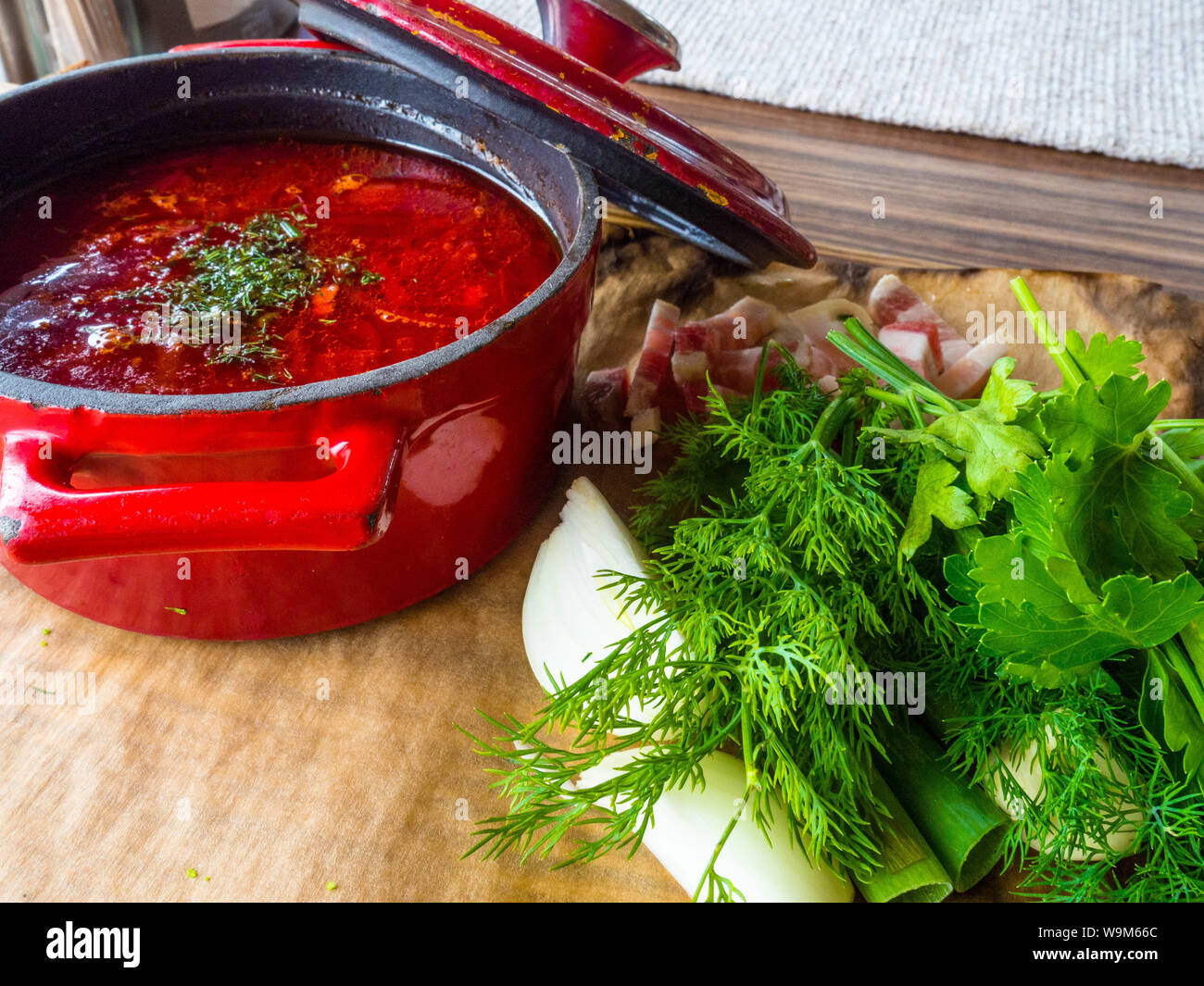 Russian borscht in red pot with garlic, parsley, dill, lard Ukrainian ...