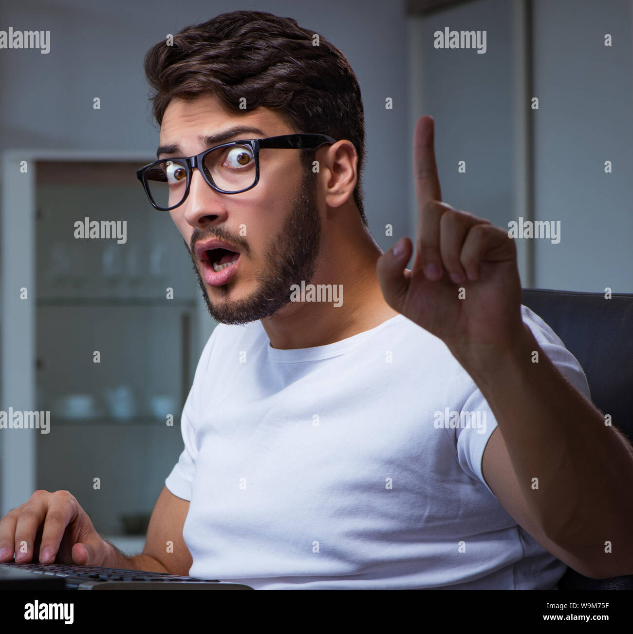 The young man staying late in office to do overtime work Stock Photo ...