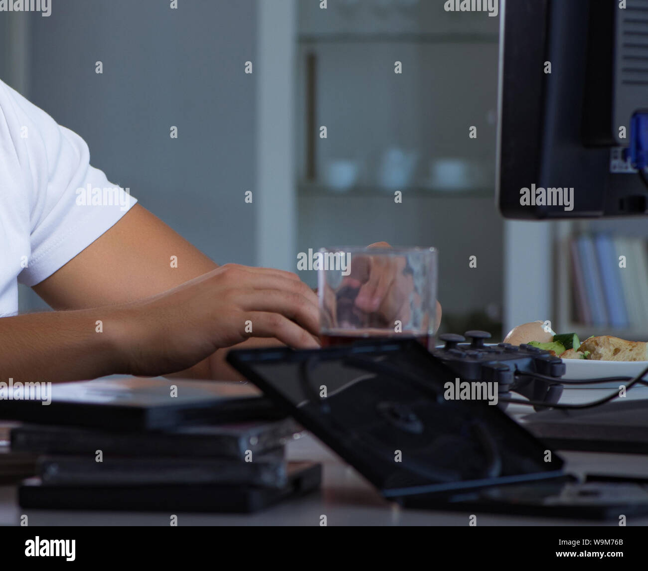 The young man staying late in office to do overtime work Stock Photo ...