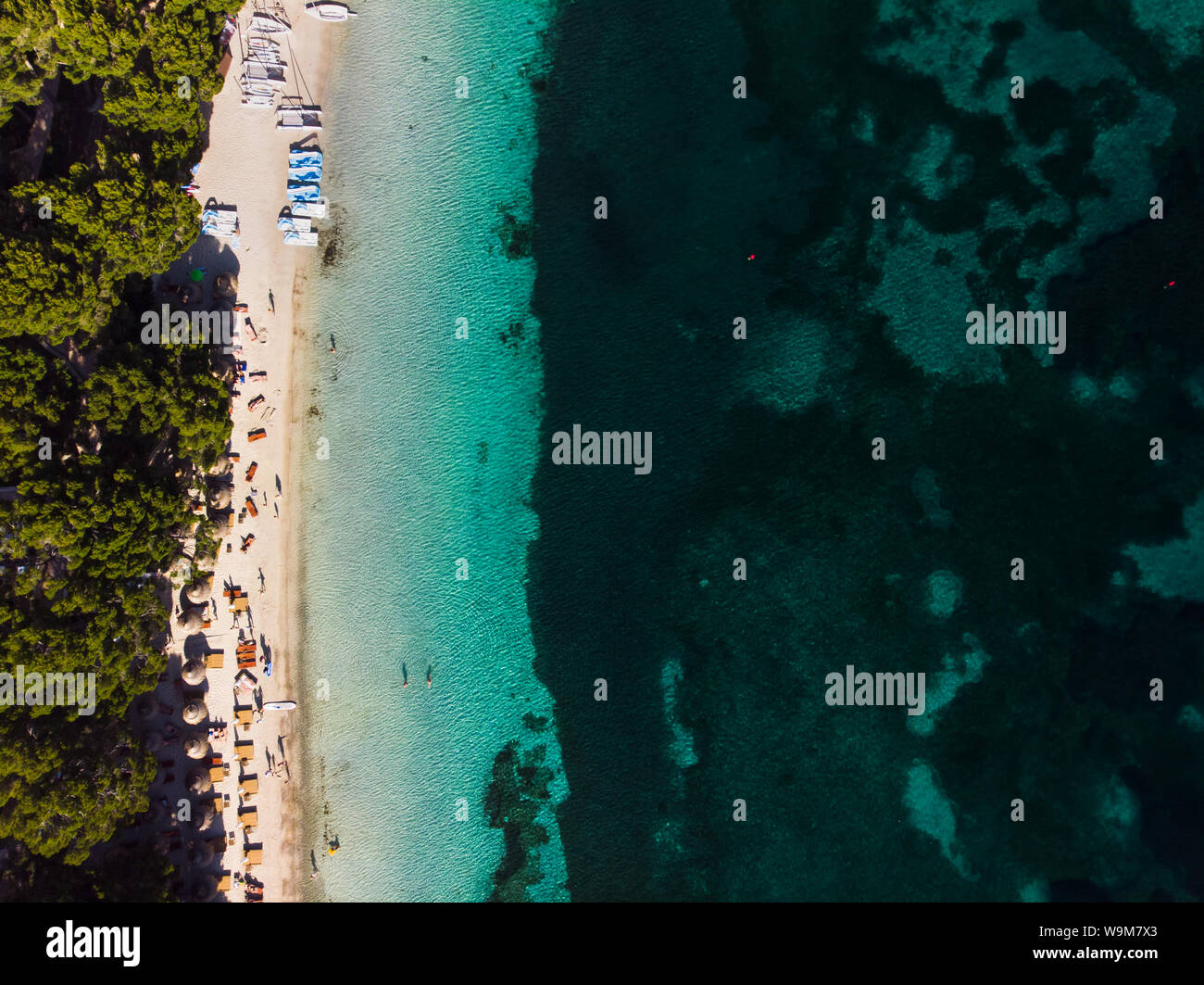 Aerial view of turquoise water of Balearic sea and green nature at ...