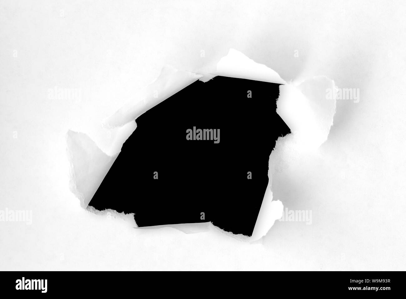Hole in Paper and Torn sides, round hole in paper on black Background ...