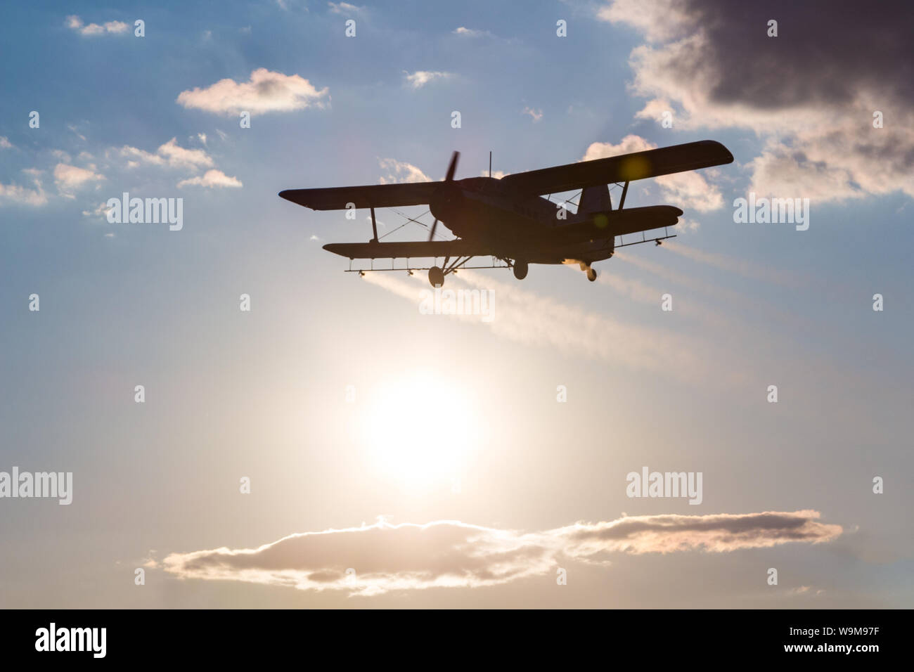 Antonov An-2 single-engine biplane spraying mosquitocide chemical over ...