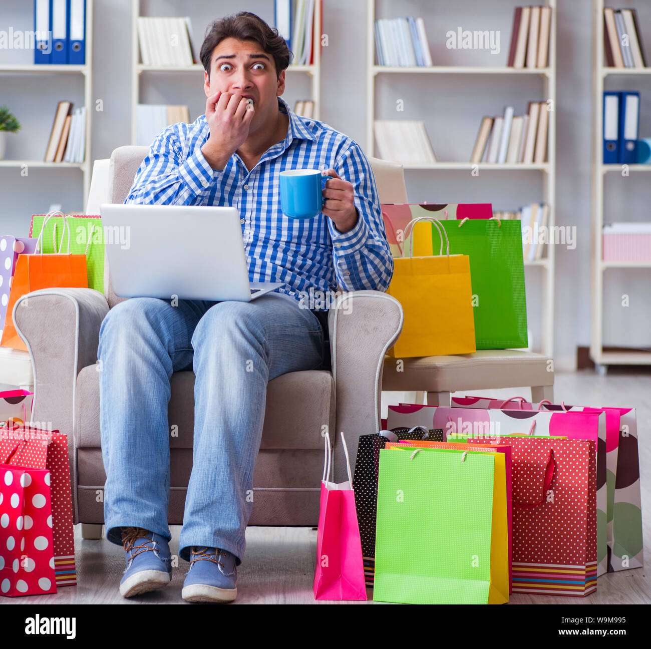 The young man after excessive shopping at home Stock Photo - Alamy