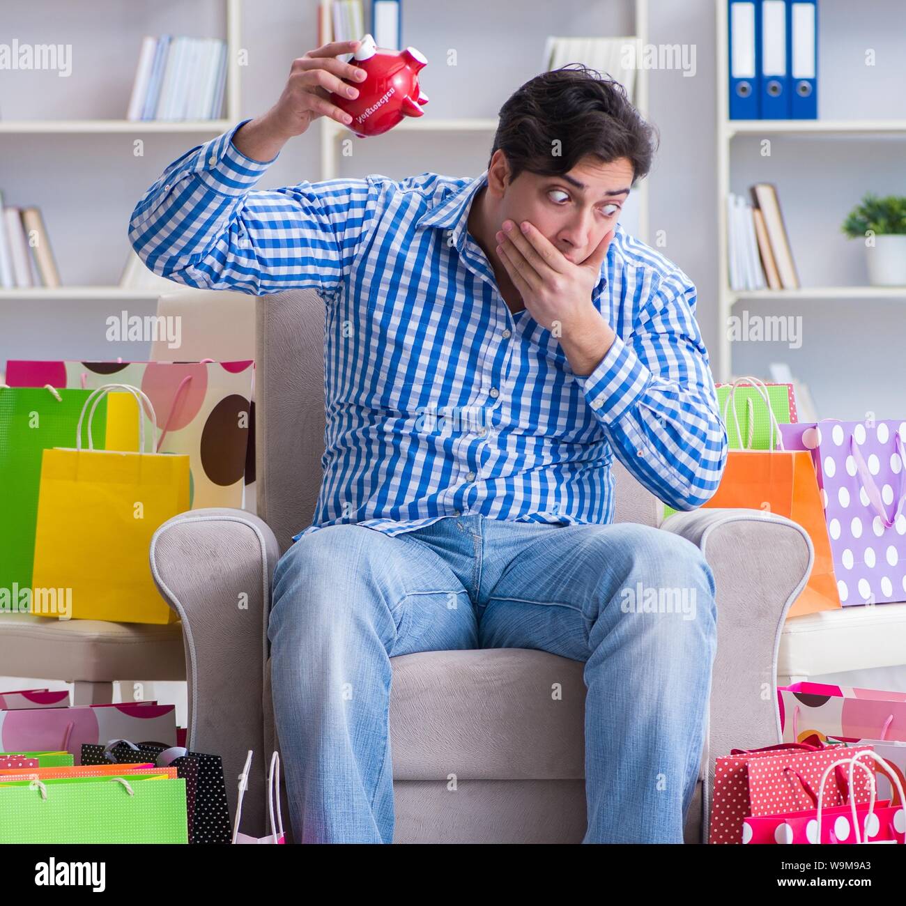 The young man after excessive shopping at home Stock Photo - Alamy