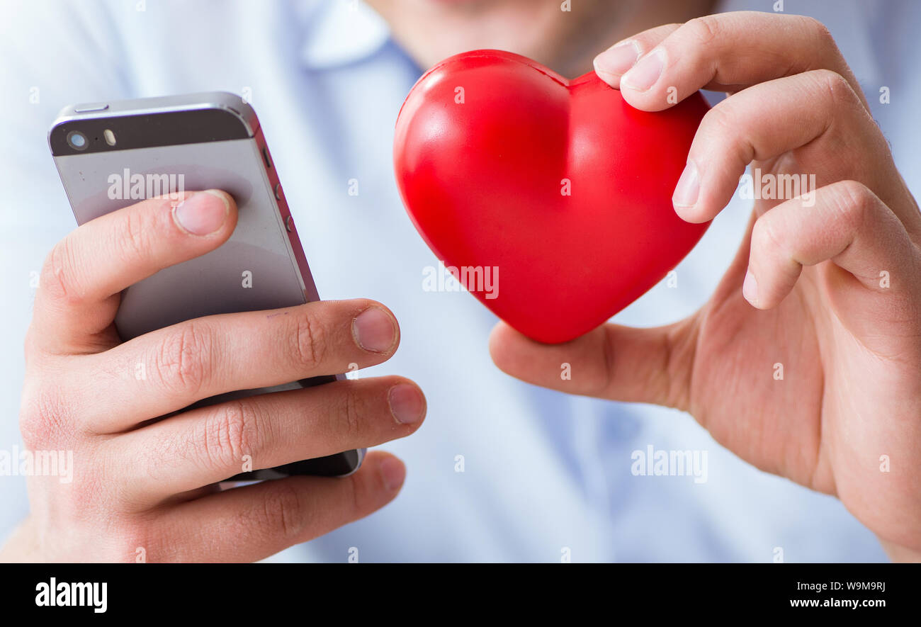 The young man chatting with his sweetheart over mobile phone Stock ...